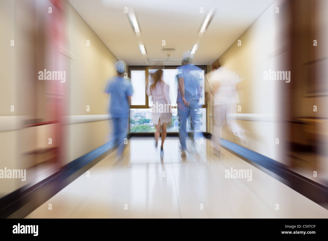 Surgeon and nurse running in passageway of hospital Stock Photo - Alamy
