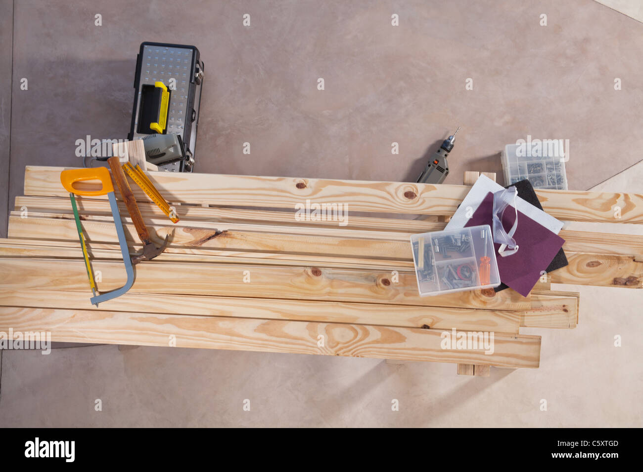 Set of construction tools lying on wooden plank Stock Photo - Alamy