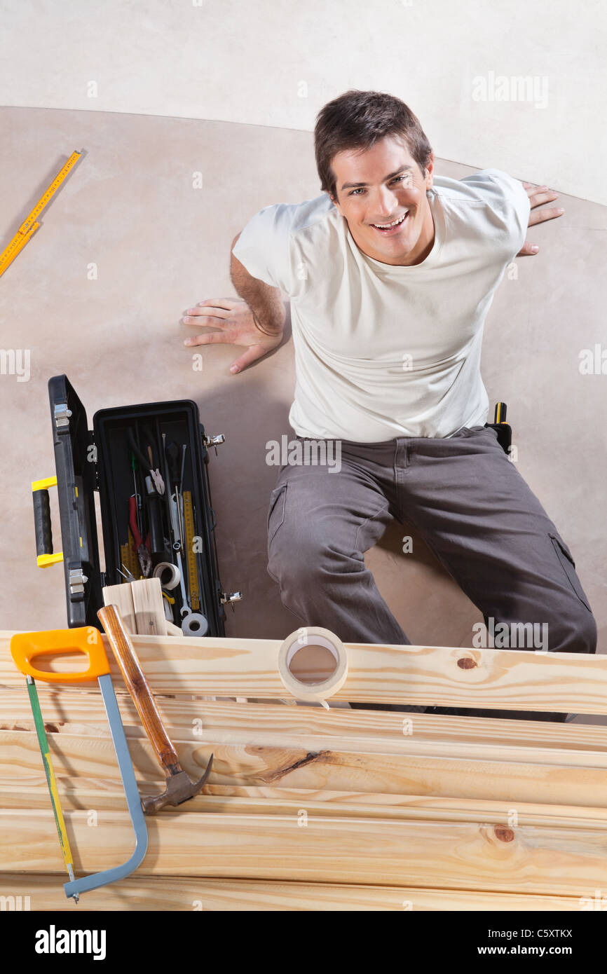 A construction worker with tools and wood Stock Photo - Alamy