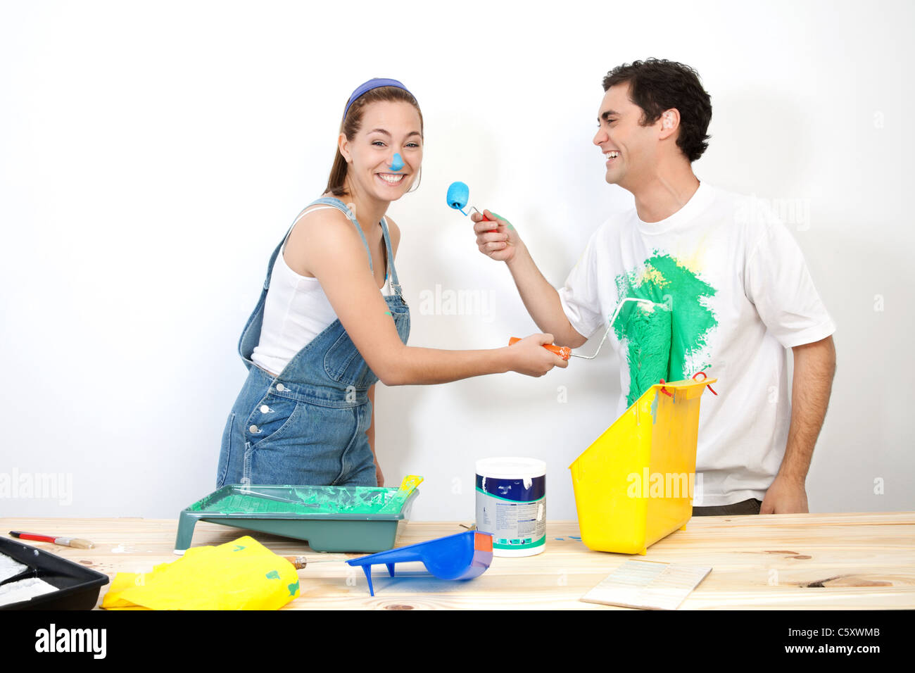 Cheerful couple doing mischief with paint Stock Photo - Alamy