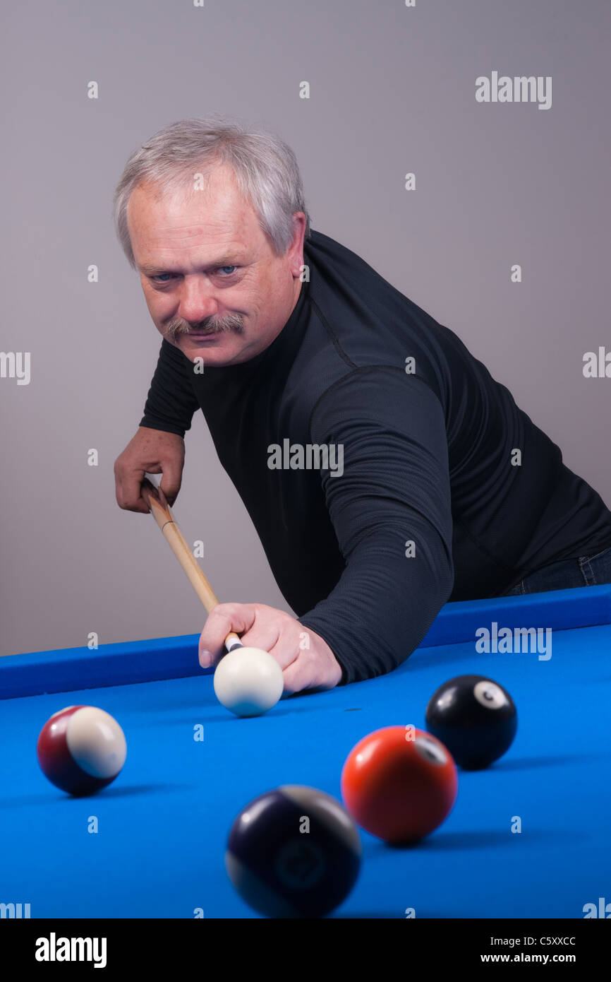 man shooting balls at a billiards hall on a blue felt table Stock Photo ...
