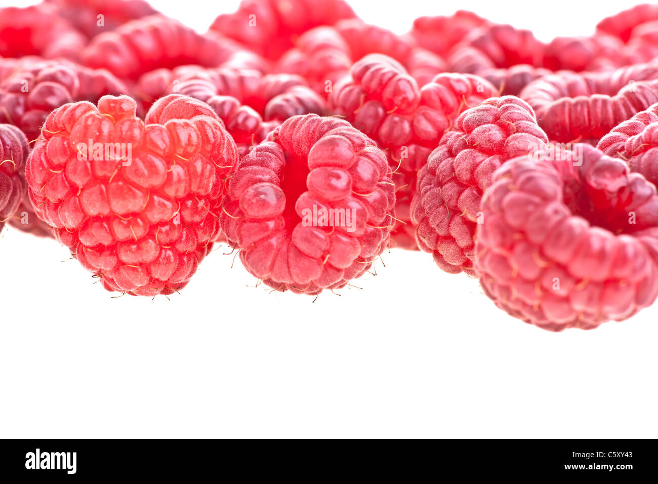 Macro of a stack of raspberries against white background Stock Photo ...