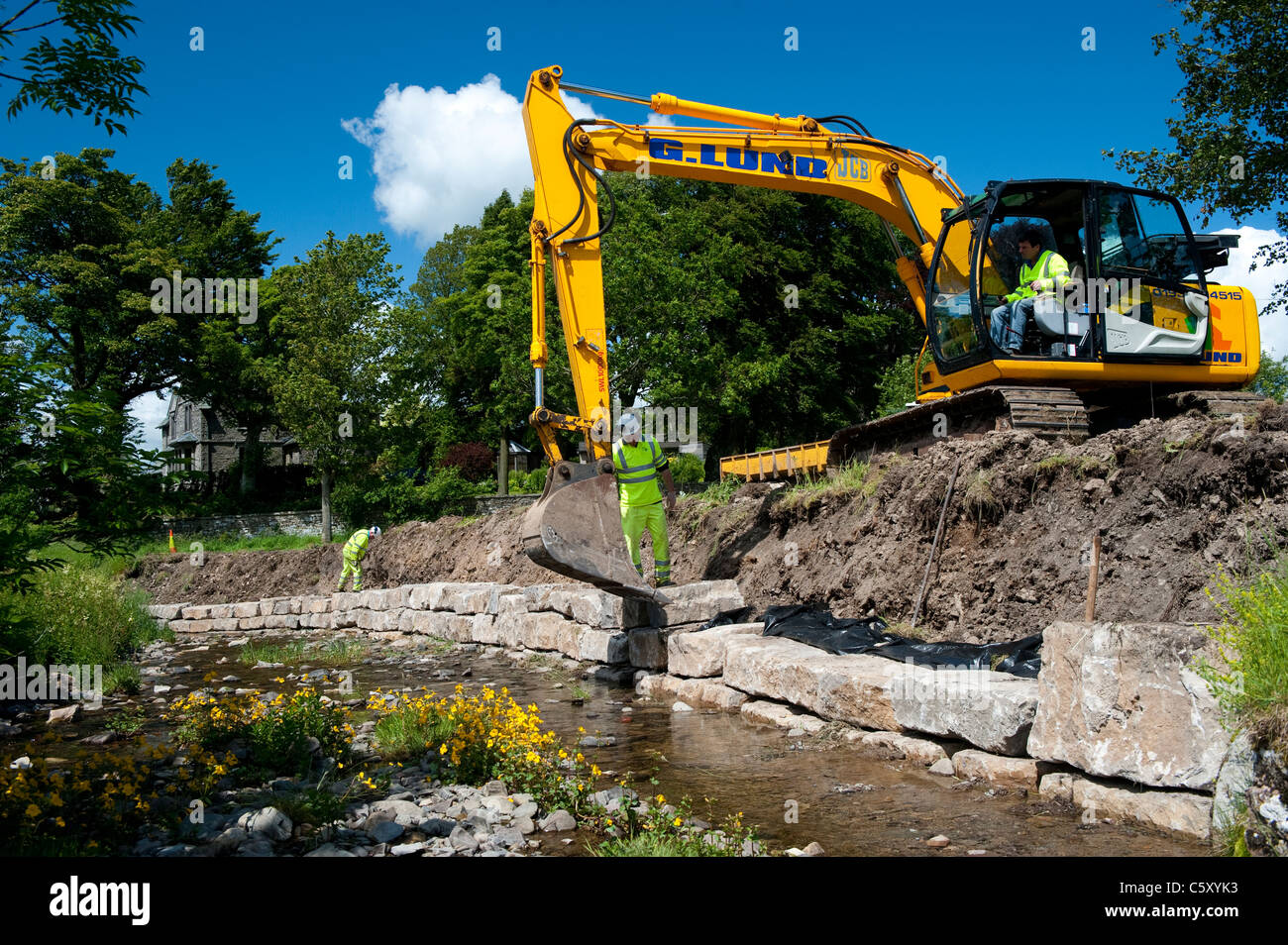 Improving river bank on stream to help prevent flooding Stock Photo - Alamy