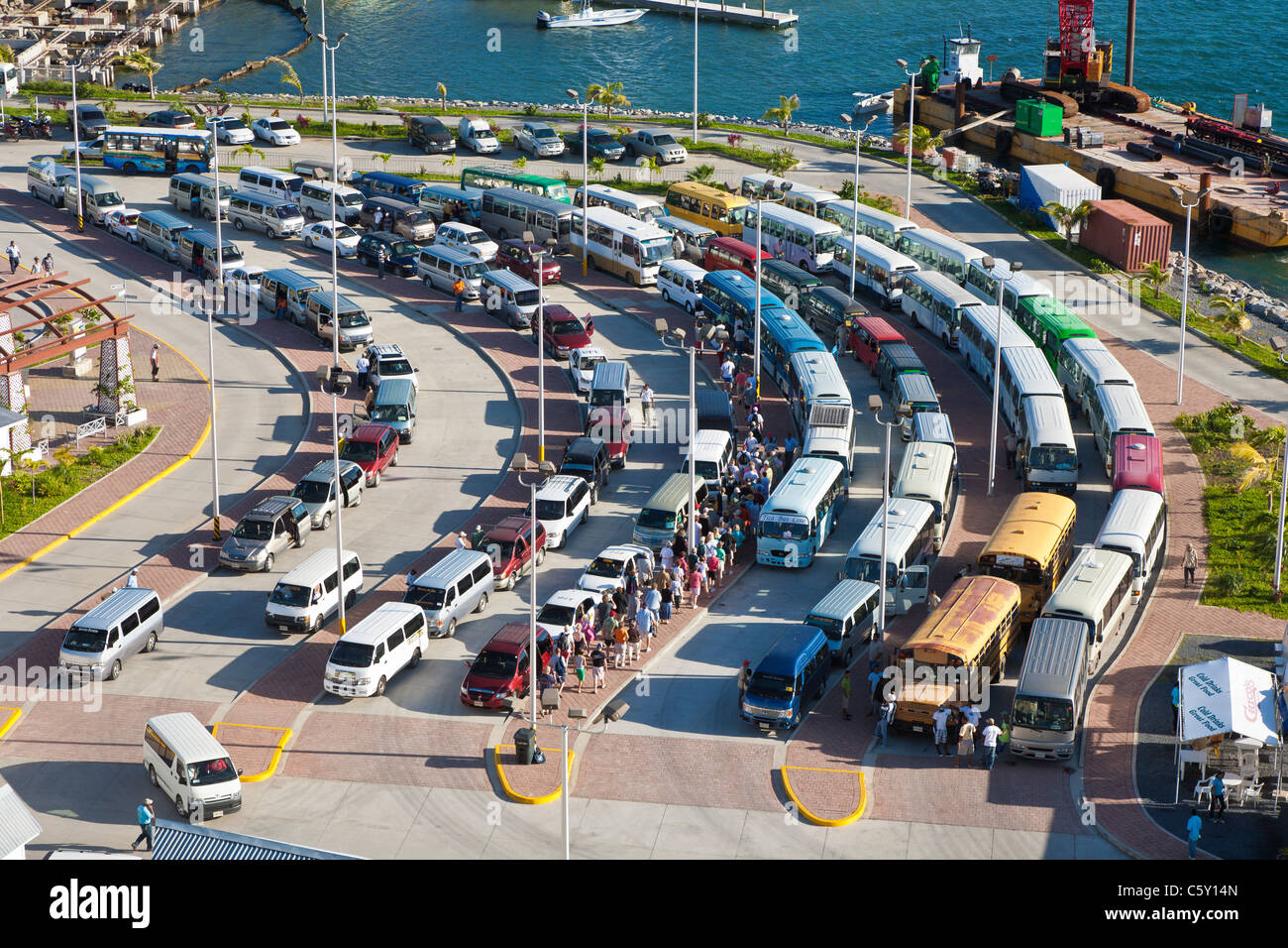 Cruise ship passengers walk to awaiting vans and buses for shore ...