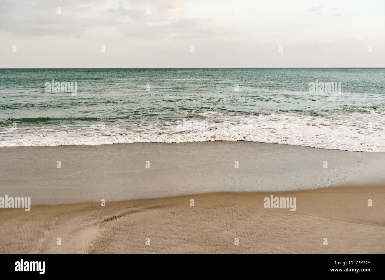 Ocean wave and sandy beach Stock Photo - Alamy