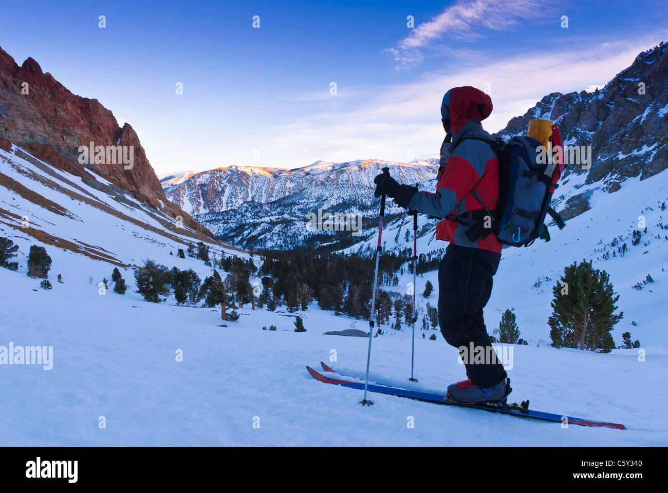 Backcountry skier enjoying the last light below Piute Pass, Inyo ...