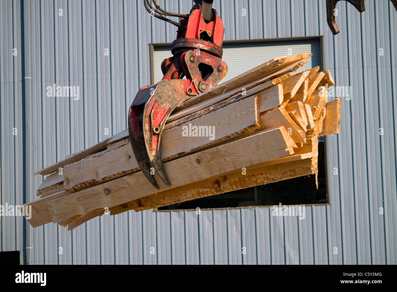 Bundle of rough cut lumber in a knuckle boom grapple Stock Photo - Alamy