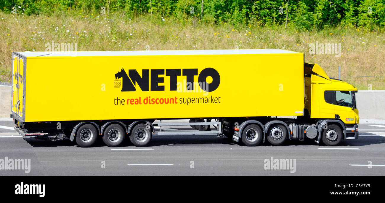 Side view yellow supply chain hgv truck & articulated trailer Netto ...
