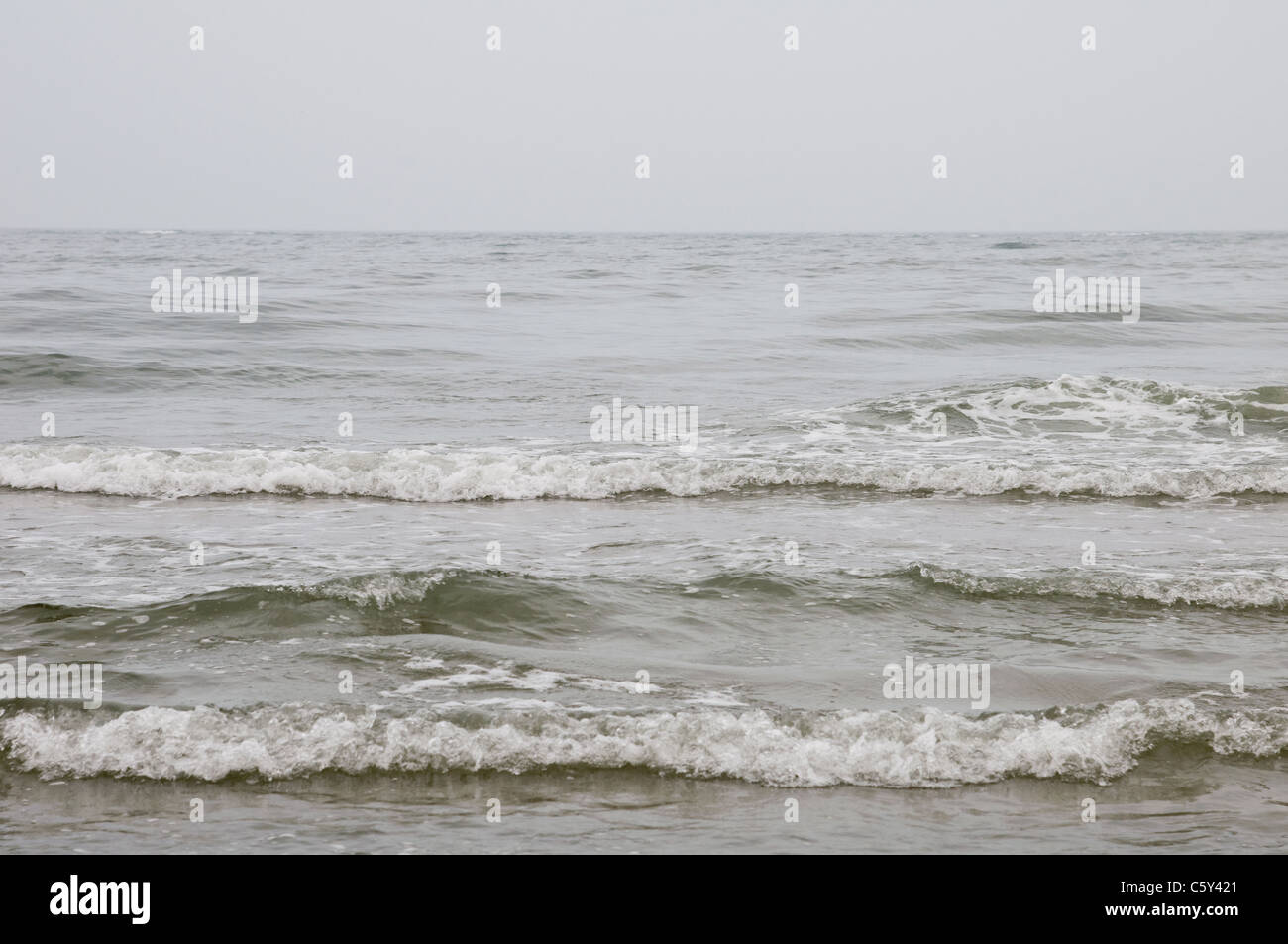 A gray seascape with a waves on against the gray sky Stock Photo - Alamy