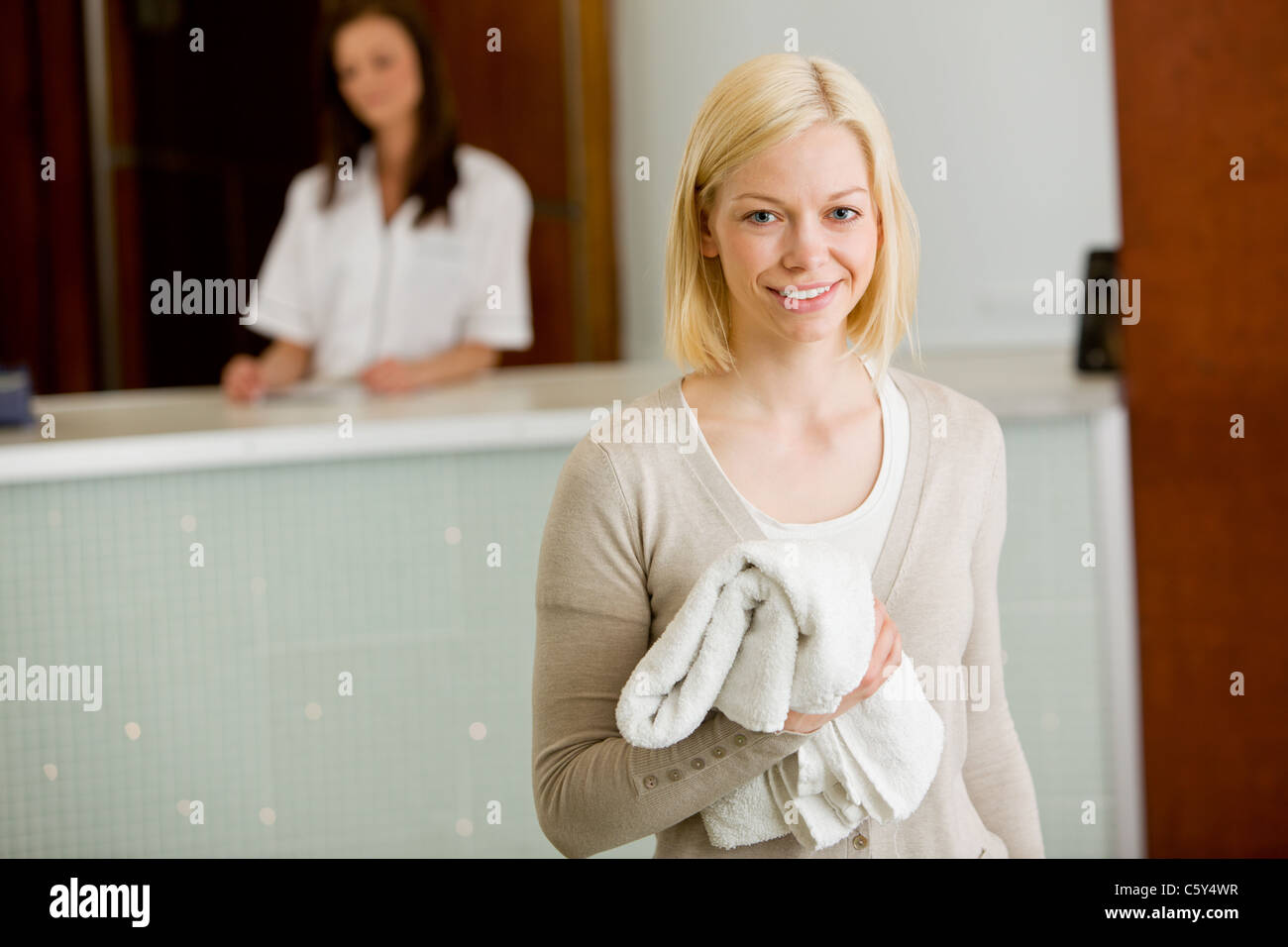 Portrait of a happy spa customer smiling and looking at the camera ...