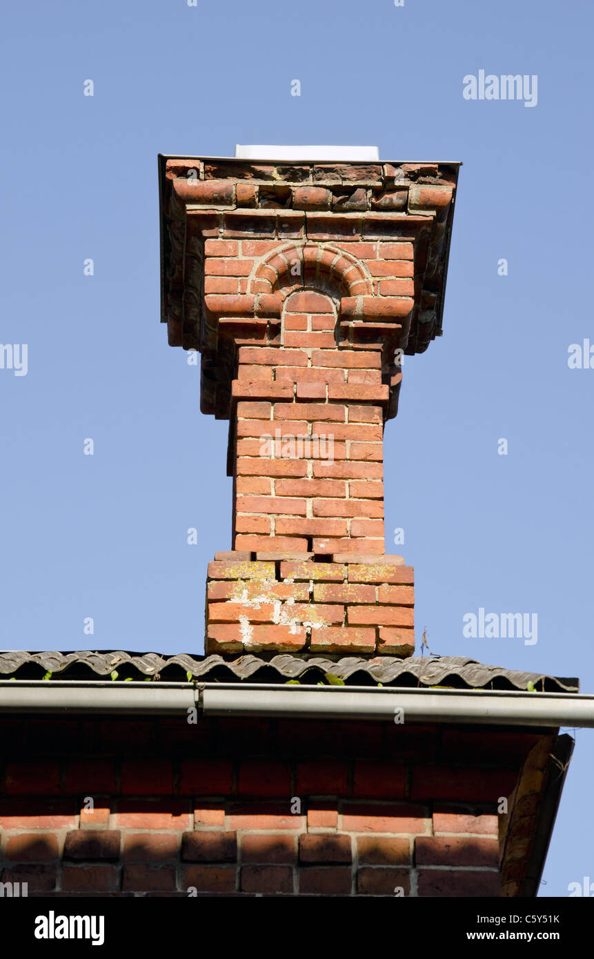 Antique, interesting shape chimney made of red bricks. Oldtown legacy ...
