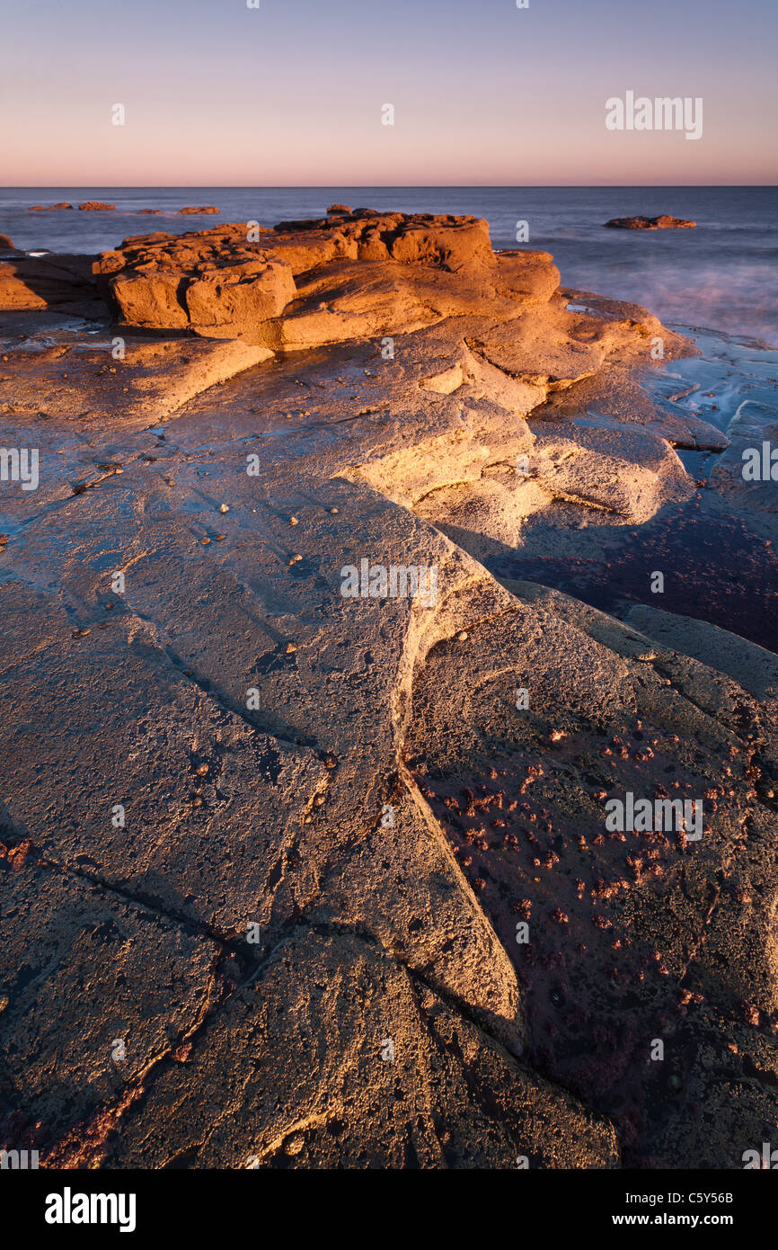 Rock Formations caught in the low light of the Sun at Saltwick Bay in ...