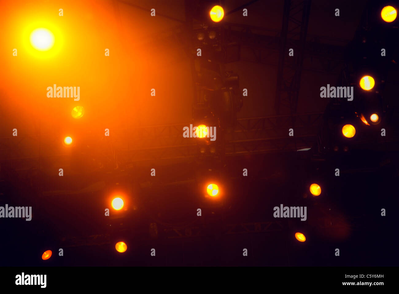 Professional concert lighting fixtures are illuminated with yellow ...