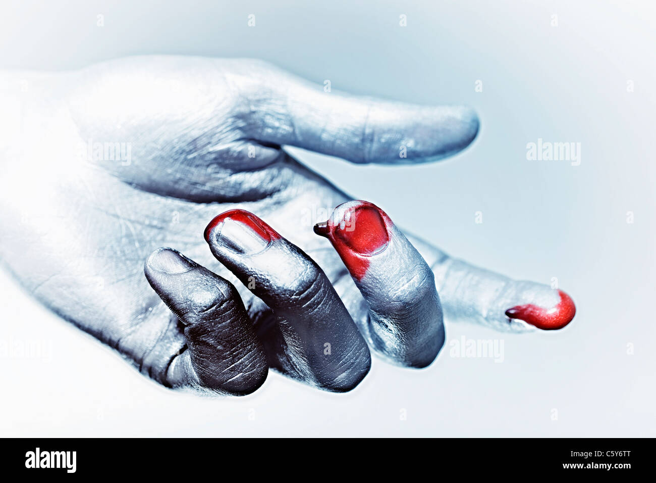 Beautiful male hand in silver paint with drops of blood Stock Photo - Alamy