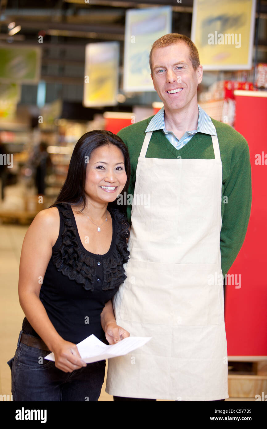 A male grocery store owner together with a customer Stock Photo - Alamy