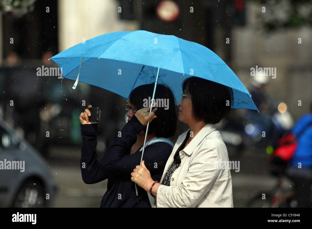 Woman umbrellas protect hi-res stock photography and images - Alamy