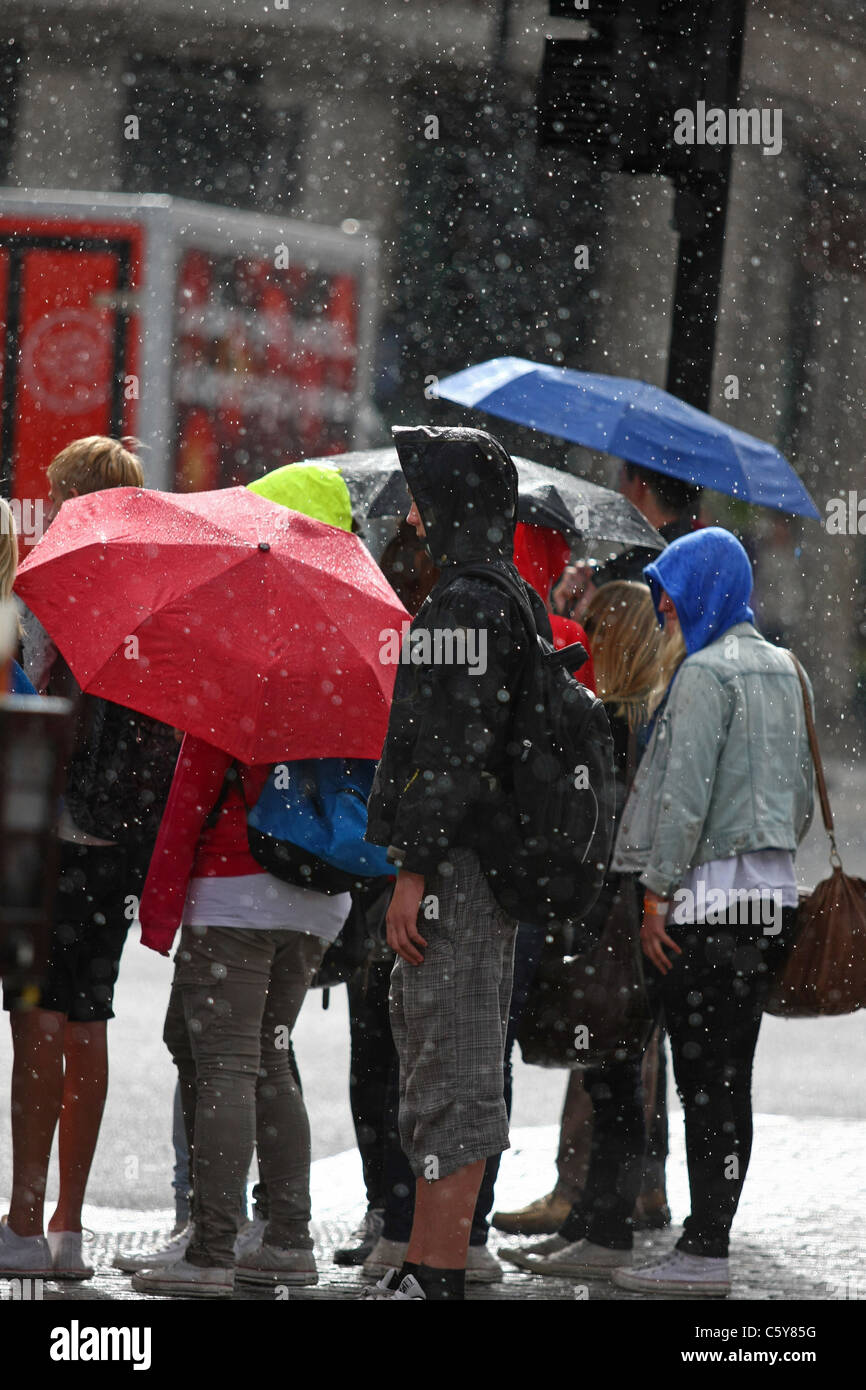 Crowd people standing under umbrellas hi-res stock photography and ...