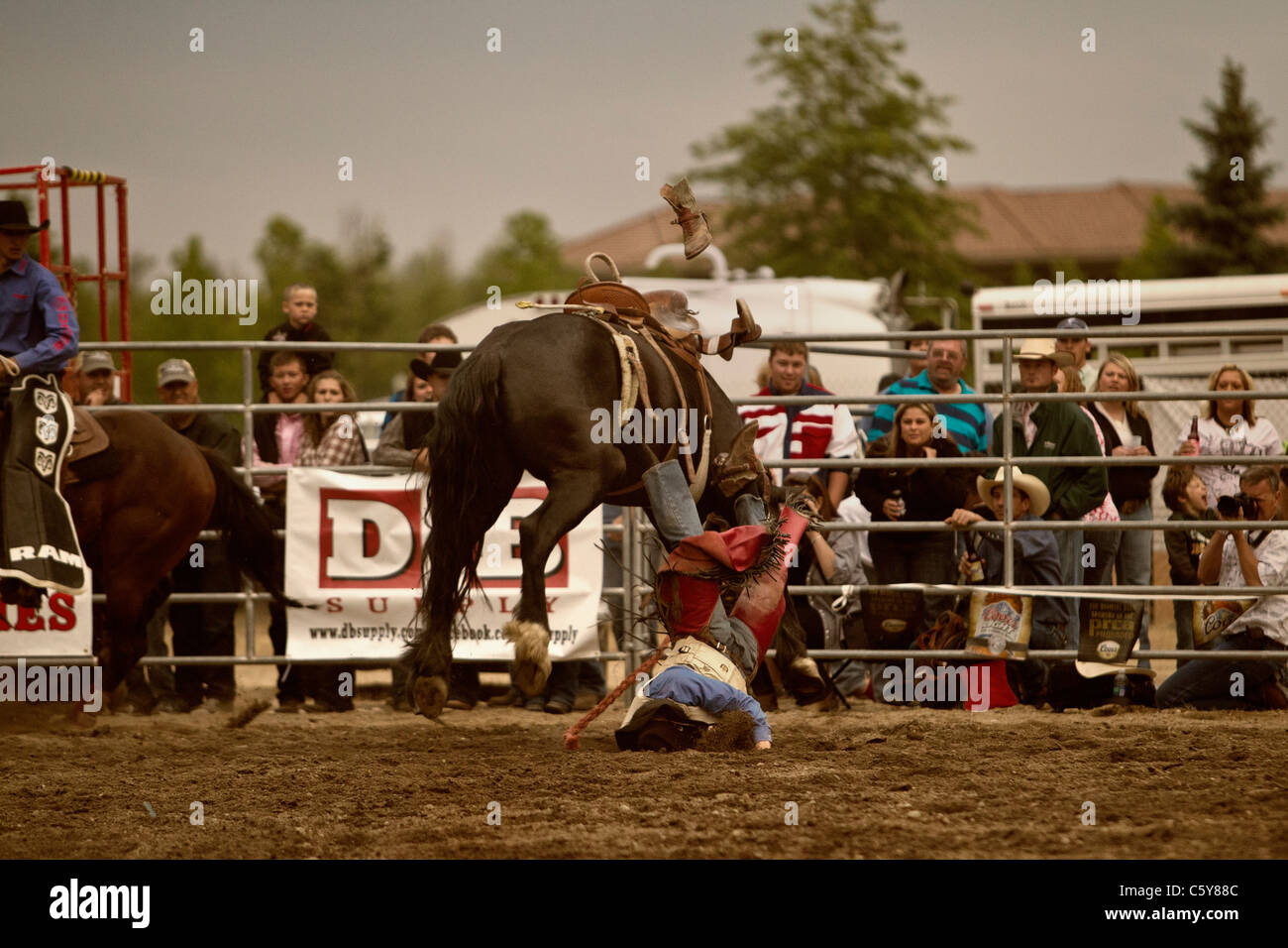 A cowboy gets bucked off a saddle bronc and loses his boot as he ...