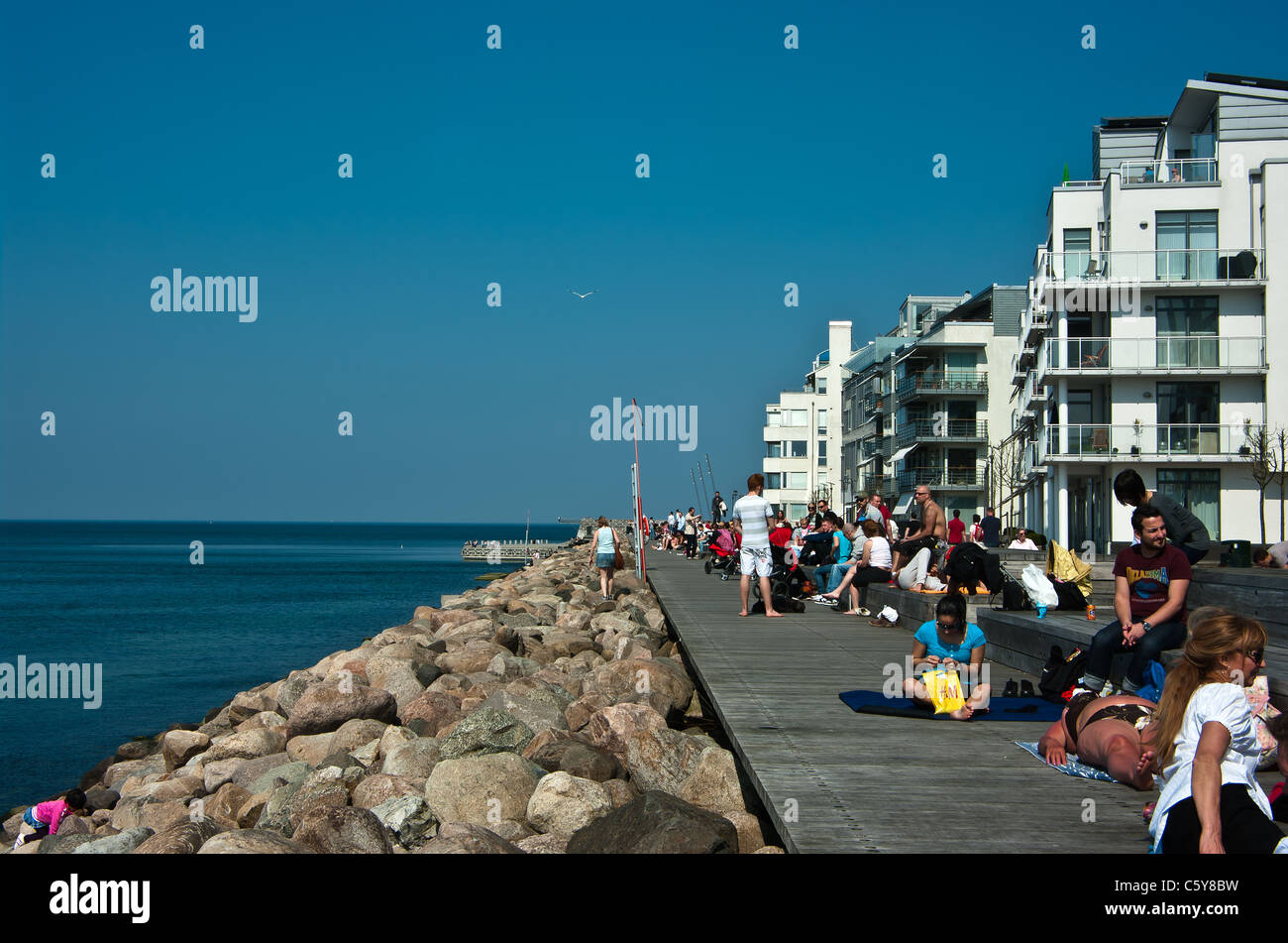 People relaxing in the sun on a bridge Stock Photo - Alamy