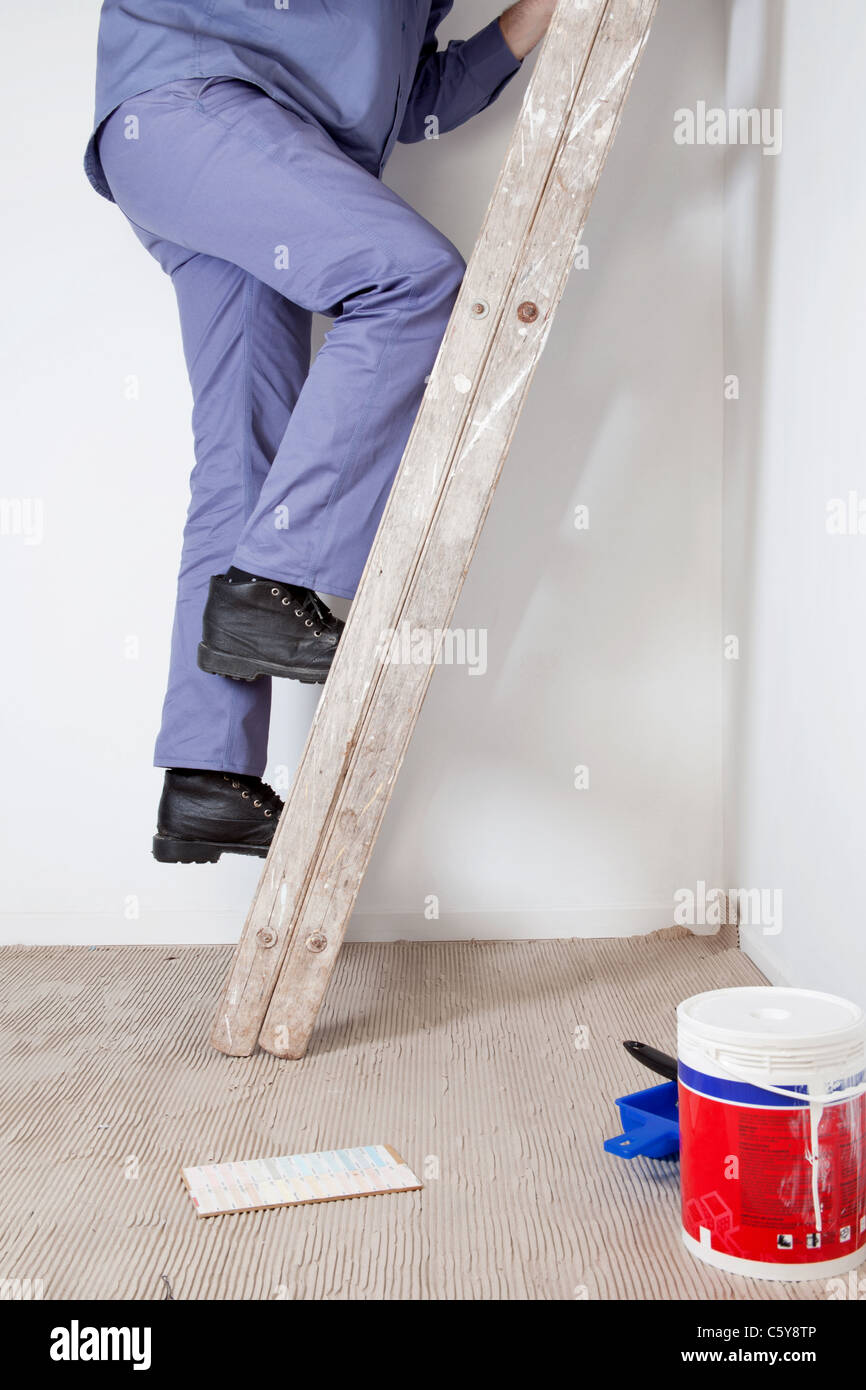 Cropped image of an workman climbing ladder at an apartment Stock Photo ...