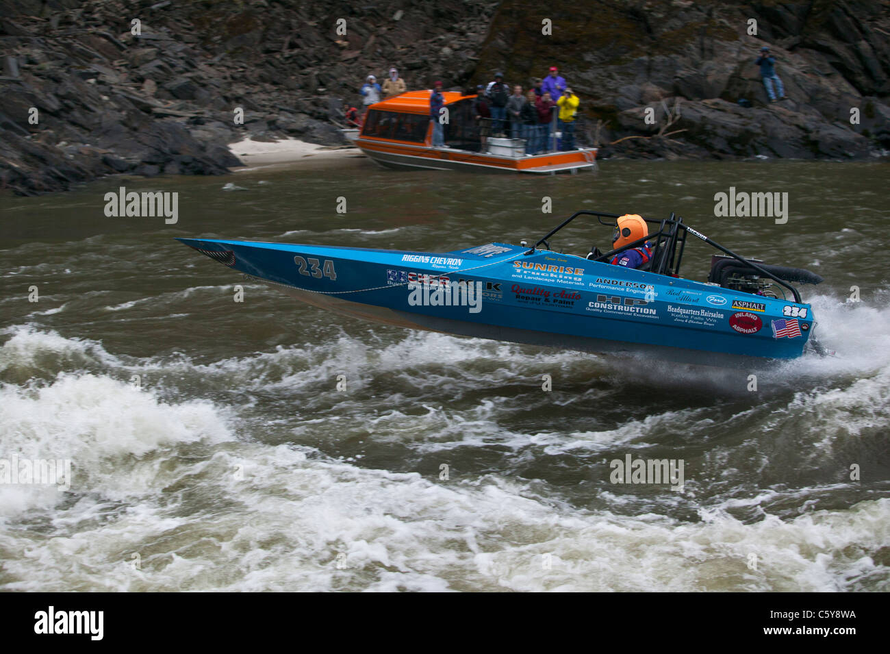 A blue jet boat jumps the rapids during the salmon River Jet Boat Race ...