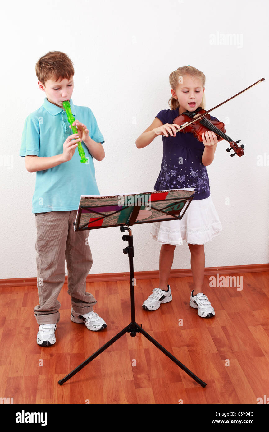 Cute kids playing flute and violin together Stock Photo - Alamy