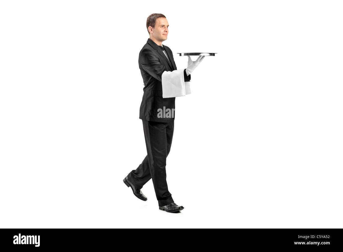 Full length portrait of a young butler with bow tie carrying a tray ...