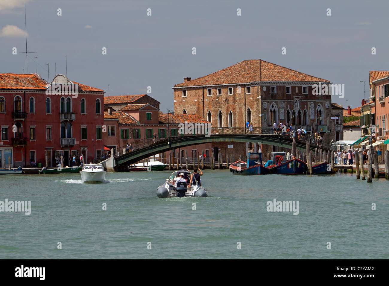 A bridge in Murano, Italy on the Mediterranean Sea, with boats, ancient ...