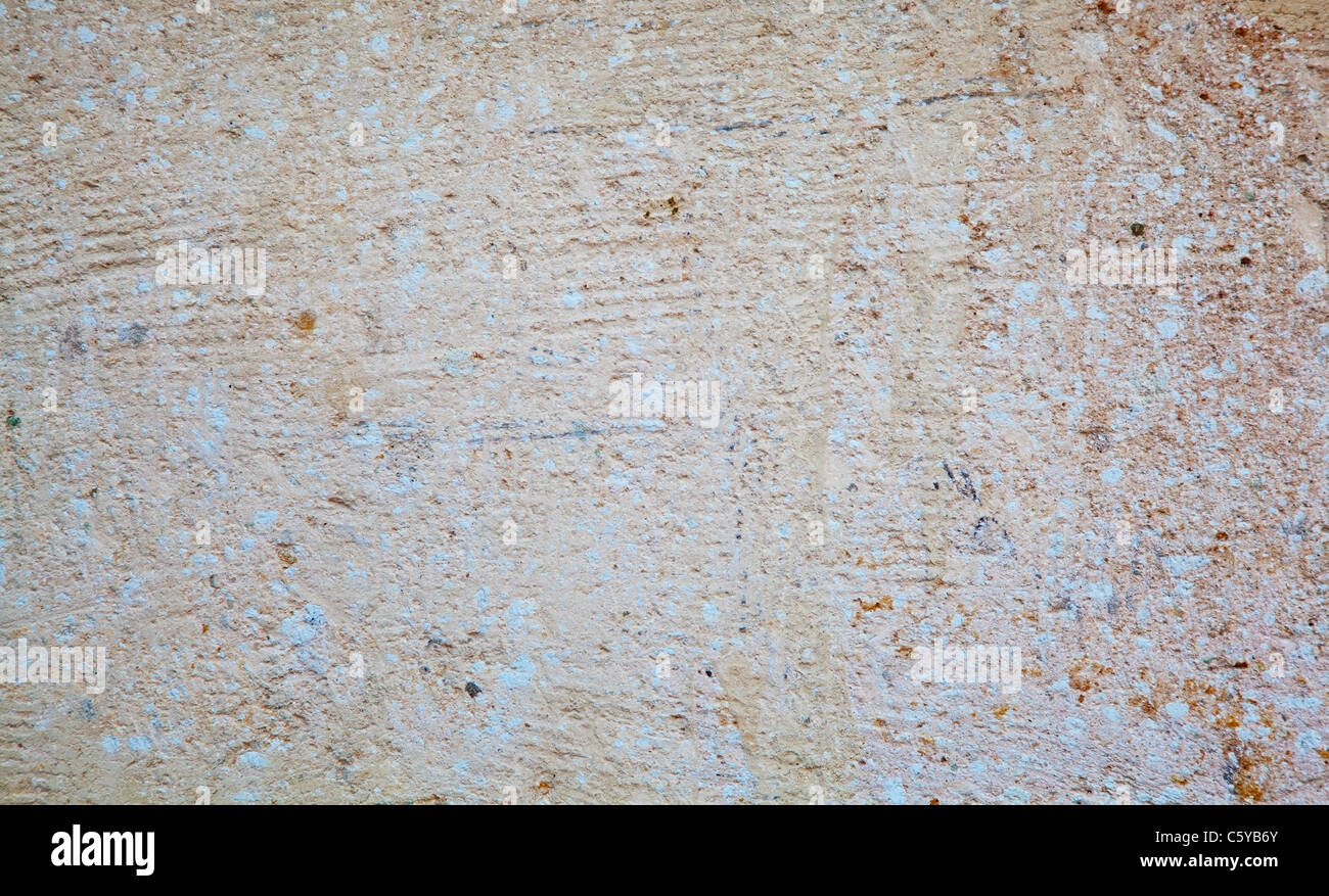 Speckled multi-colored limestone block textured with chiseled ...