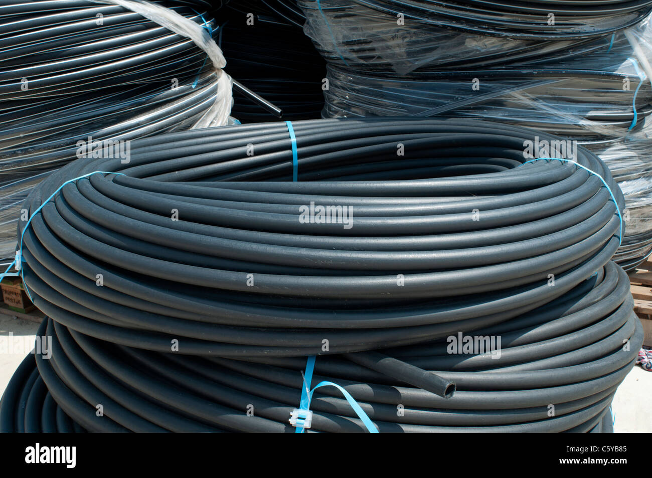 Coiled black PVC hoses. Polyethylene tubing Stock Photo - Alamy