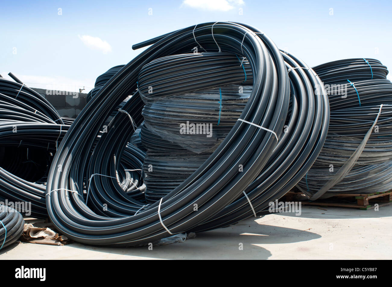 Coiled black PVC hoses. Polyethylene tubing Stock Photo - Alamy
