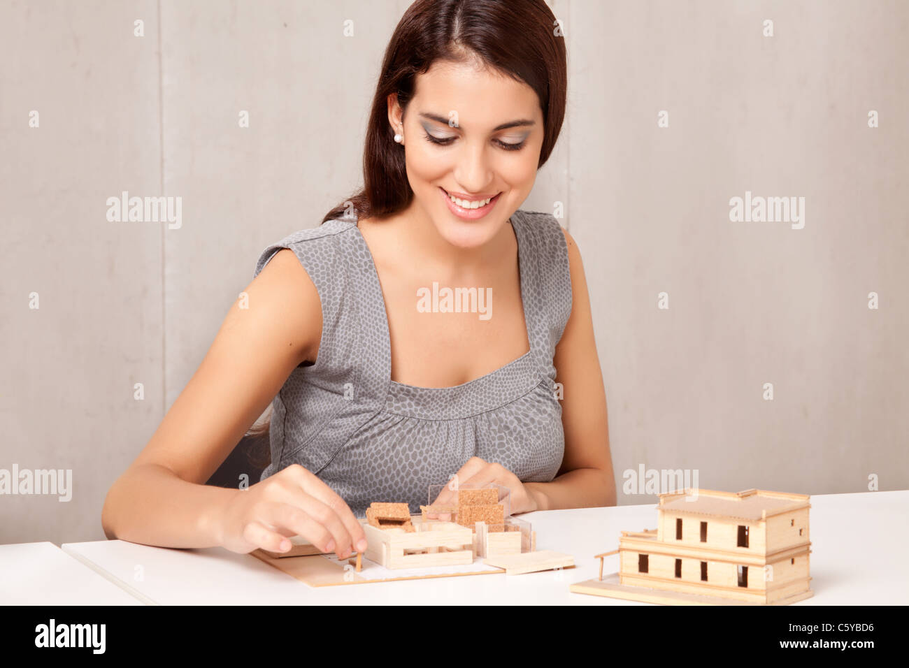 A female interior designer working on a scale model Stock Photo - Alamy