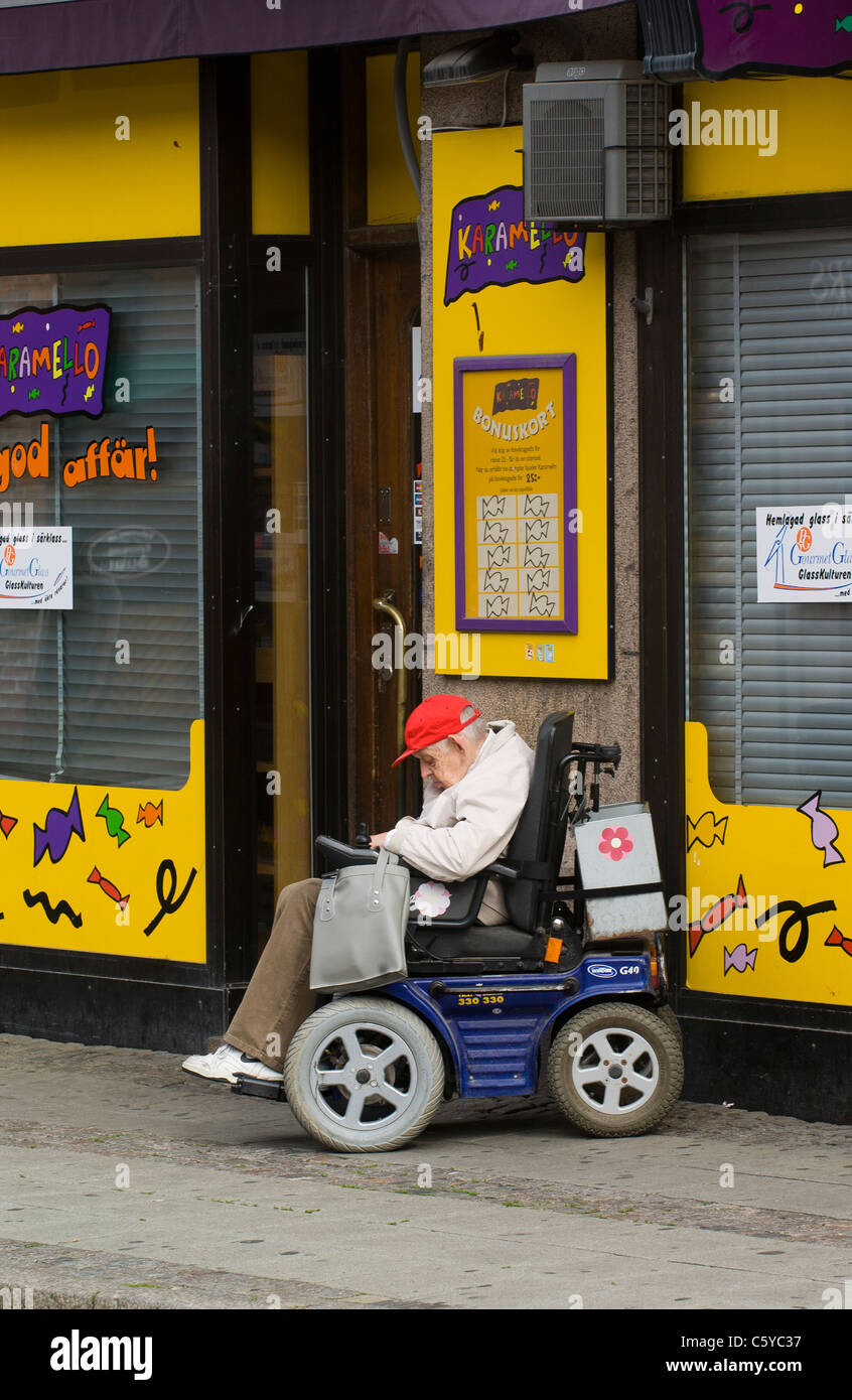 An old woman with a powered wheelchair Stock Photo - Alamy