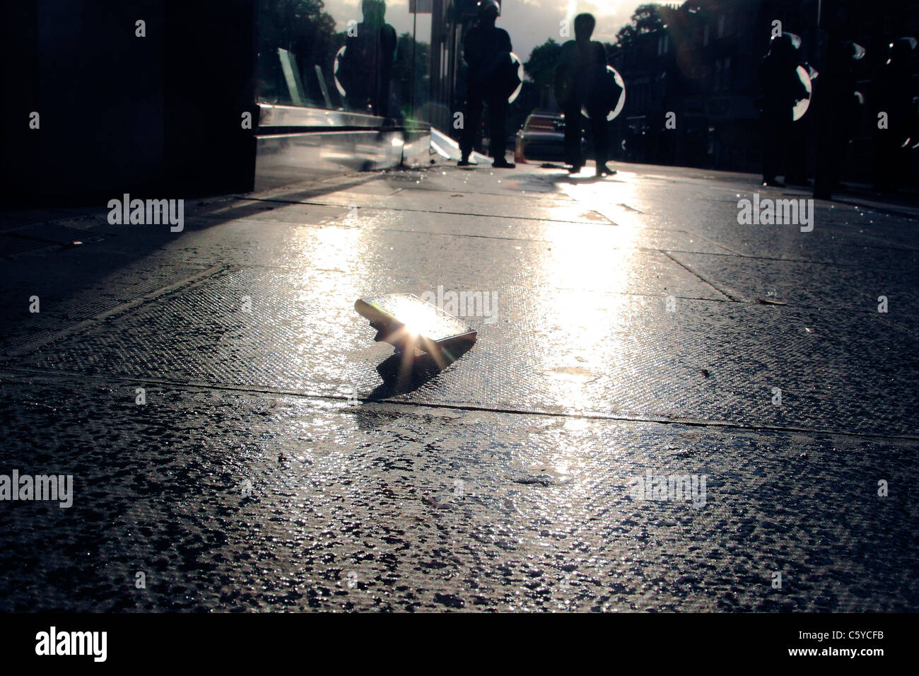 A mobile phone lays discarded by looters in Enfield town center Stock ...