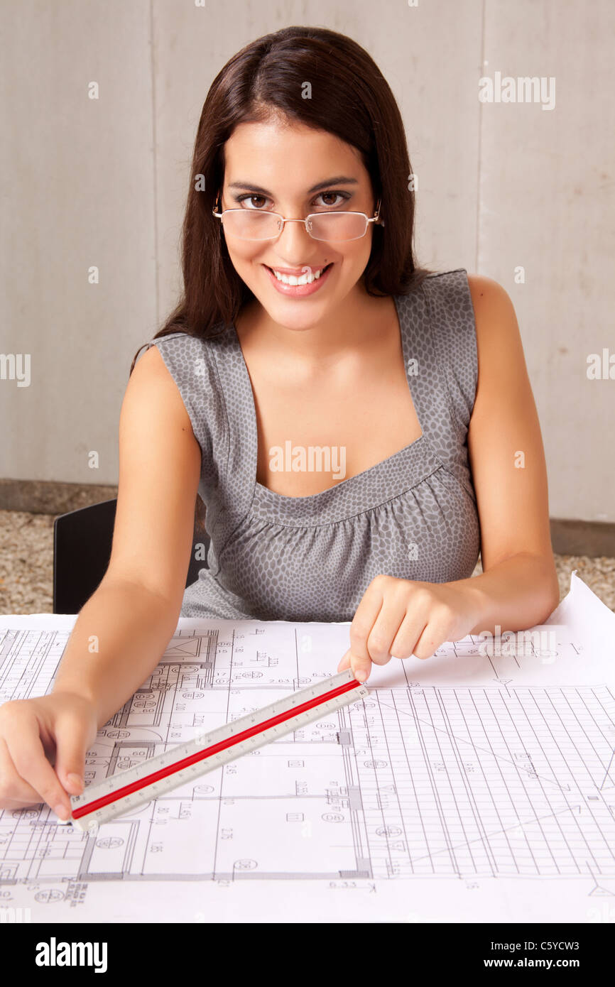 An architecture checking measurements on a set of blueprints Stock ...