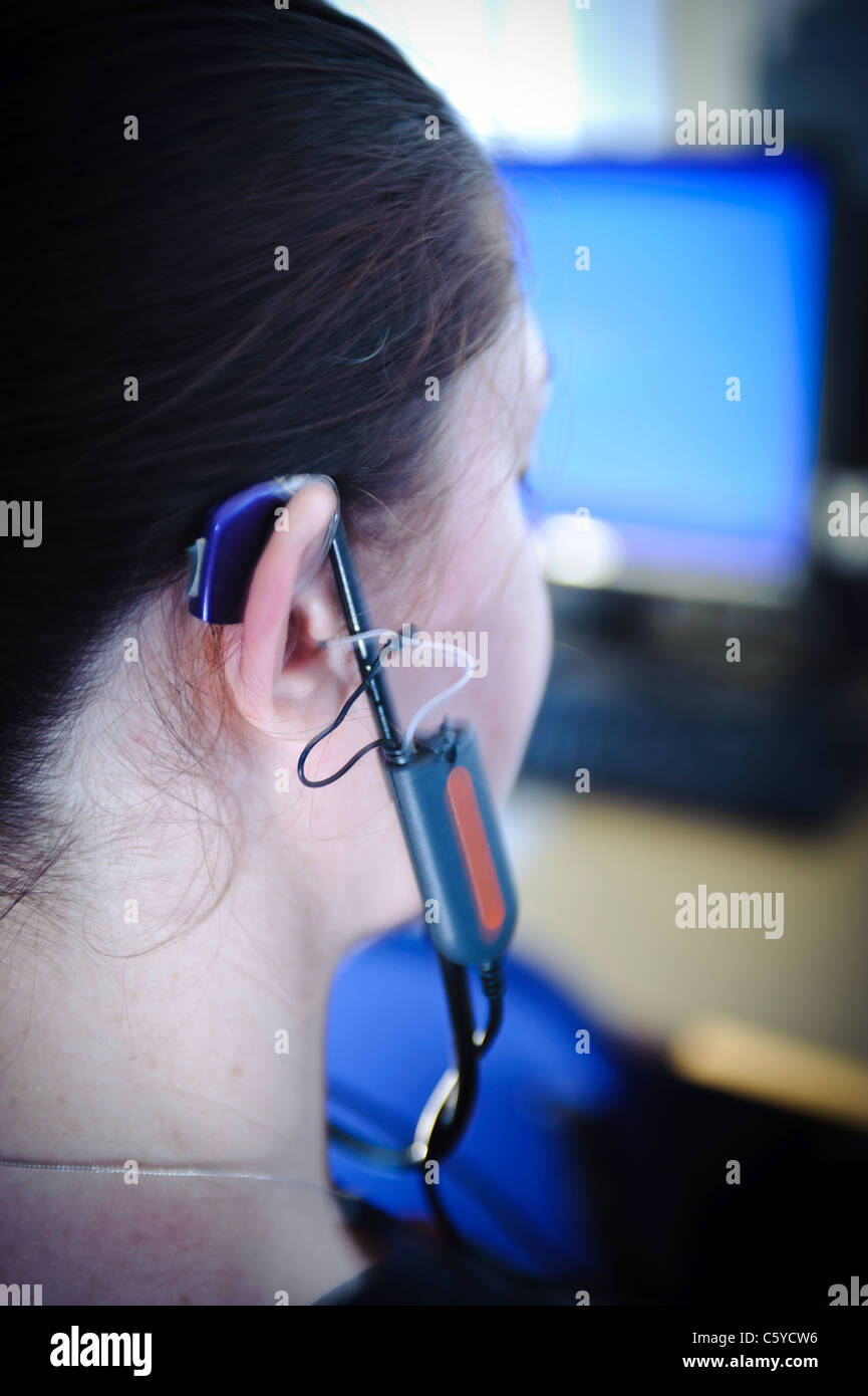 Young female audiology student wearing a hearing aid apparatus for a ...