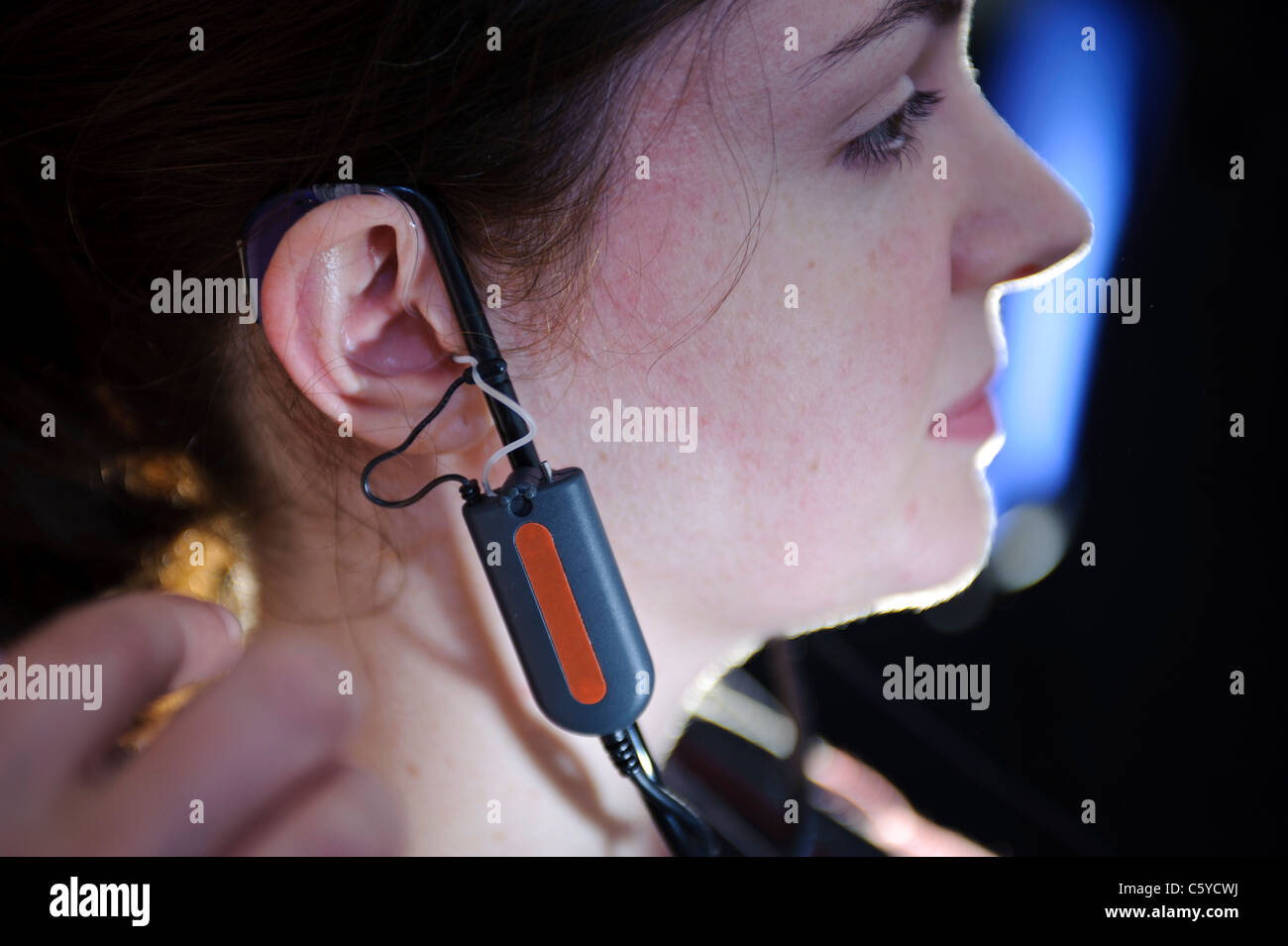 Young female audiology student wearing a hearing aid apparatus for a ...