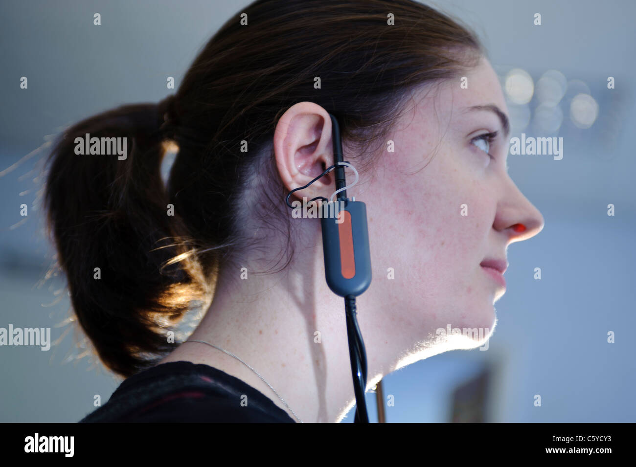 Young female audiology student wearing a hearing aid apparatus for a ...