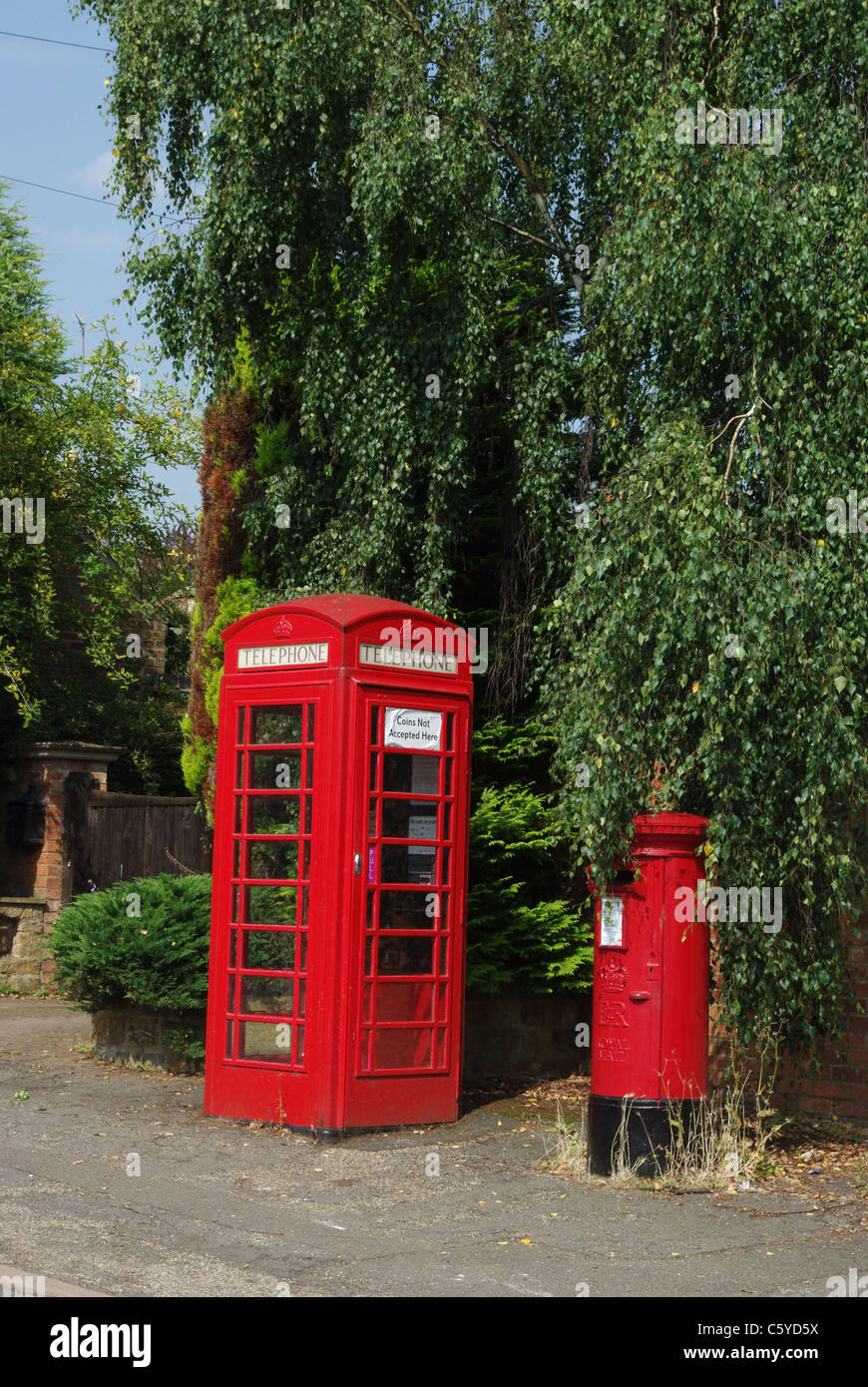 Red phone box and red pillar box in the village of Spratton, UK Stock ...