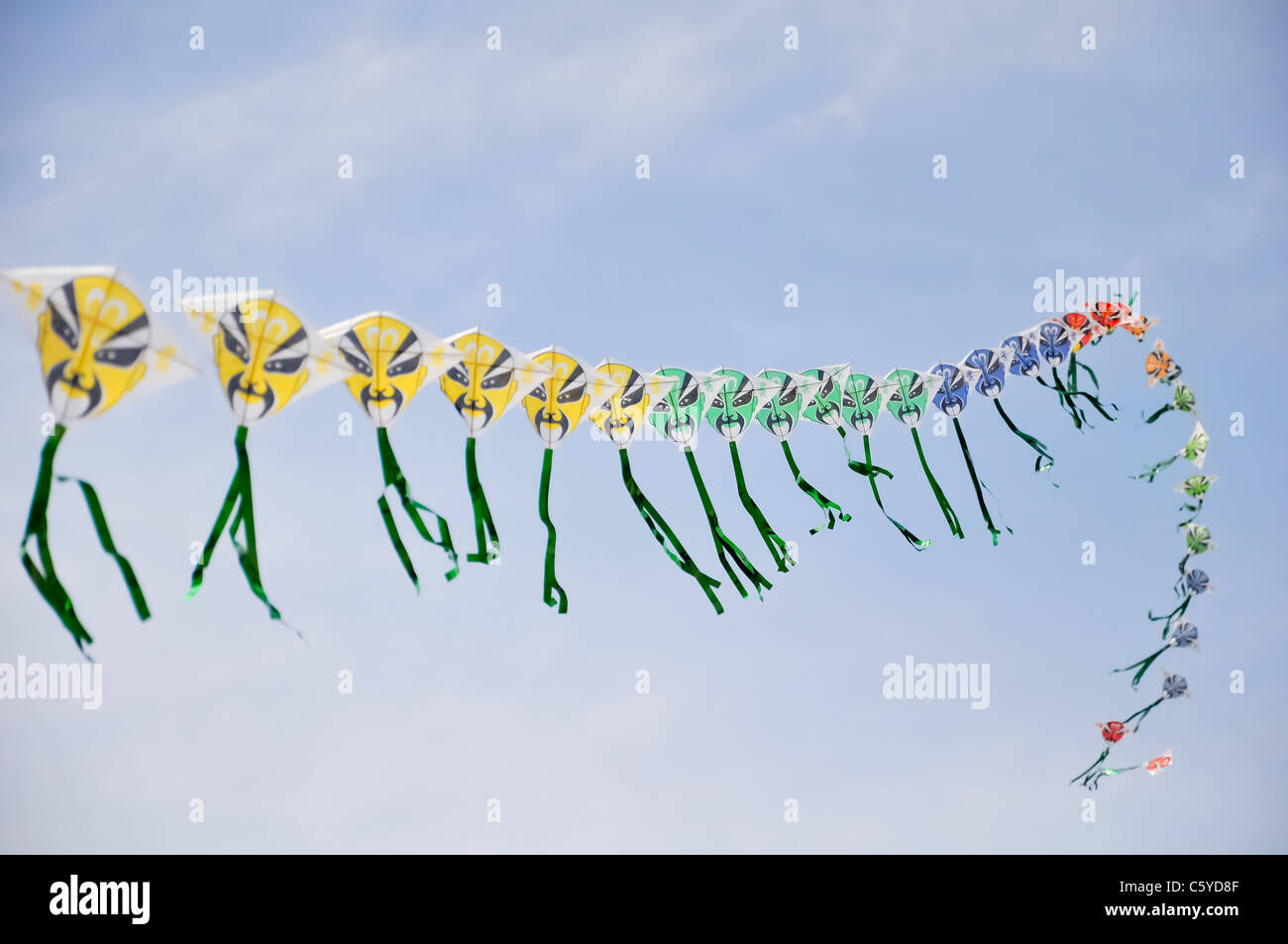 a string of colorful chinese kites depicting chinese traditional masks ...