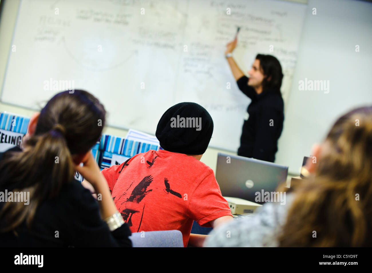 school children aged 12-13 years in classroom camera behind facing ...