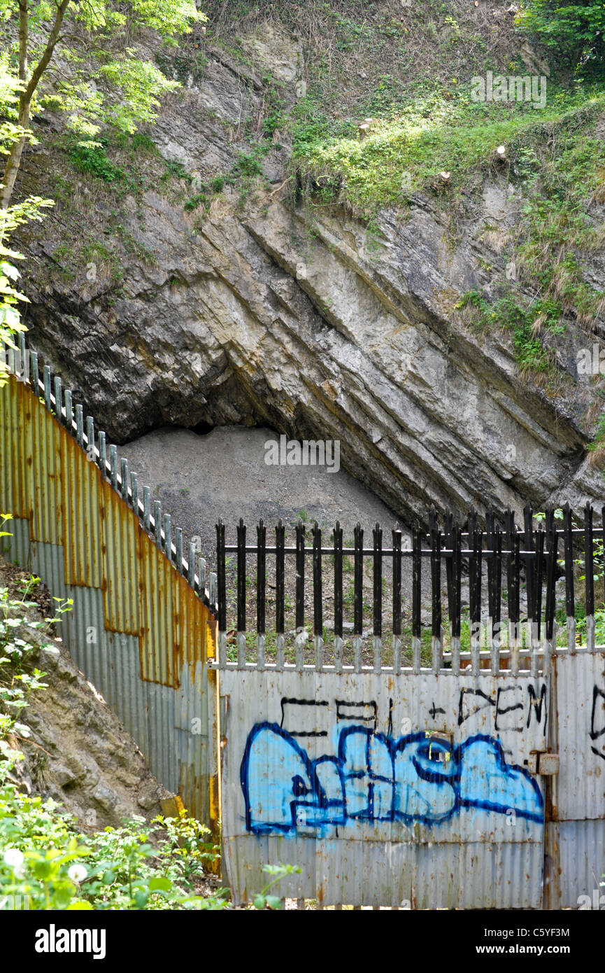 Graffiti on metal railings protecting old limestone mine works and ...