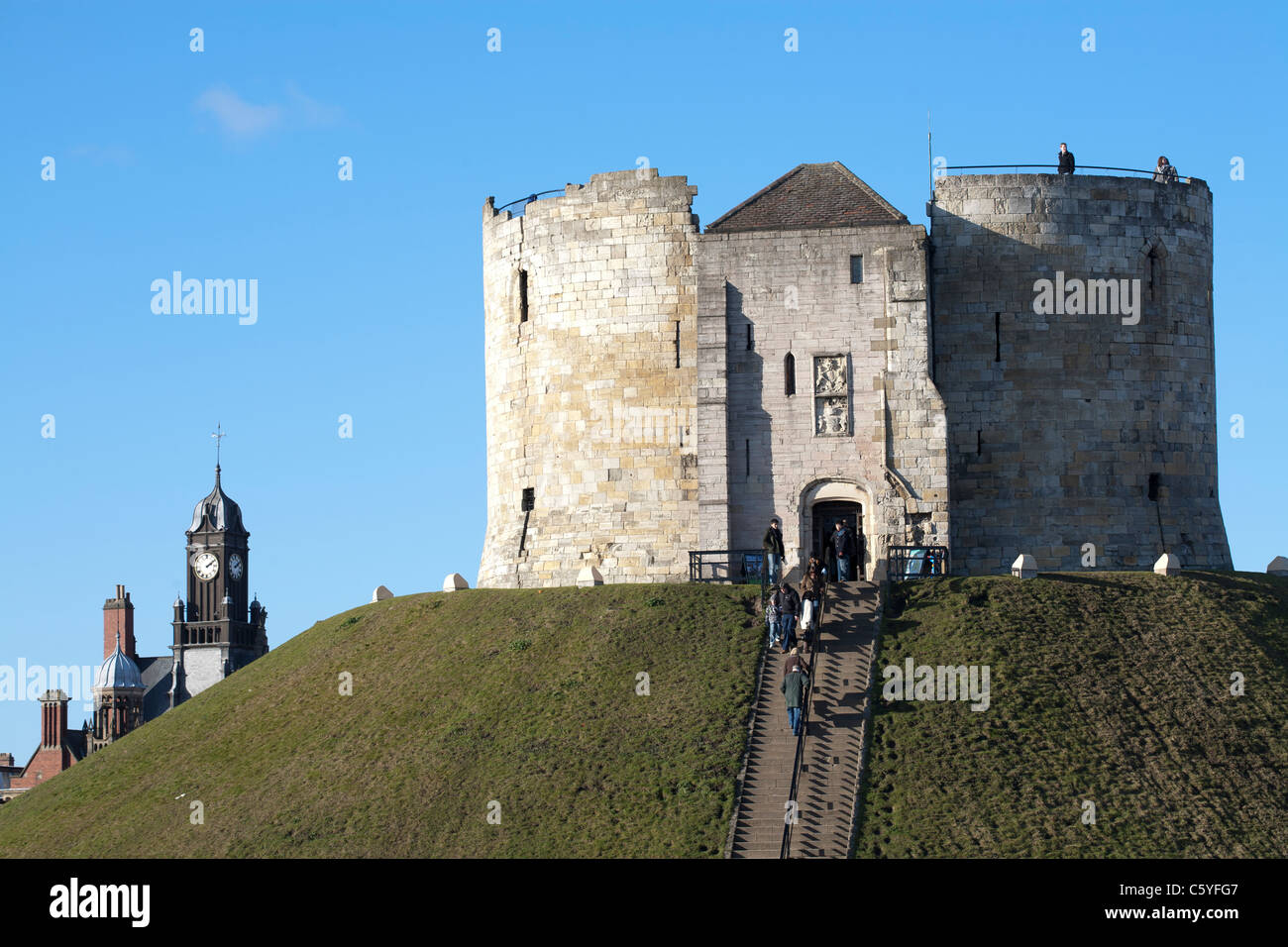 A view of the thirteenth century Clifford's tower in York, with clock ...