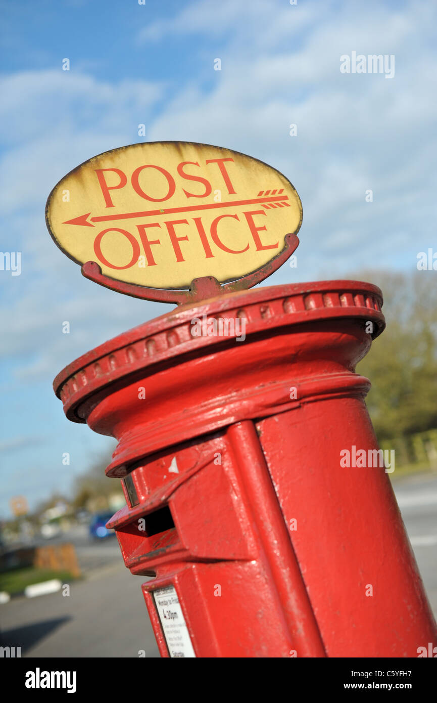 Traditional English red pillar box with a rare Post Office sign on top ...