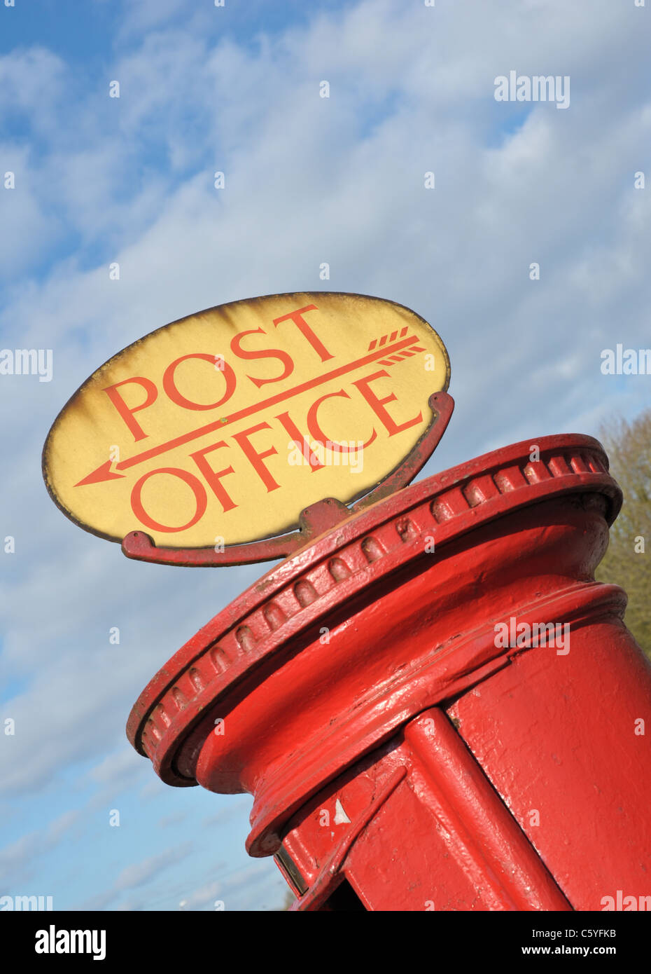 Traditional English red pillar box with a rare Post Office sign on top ...