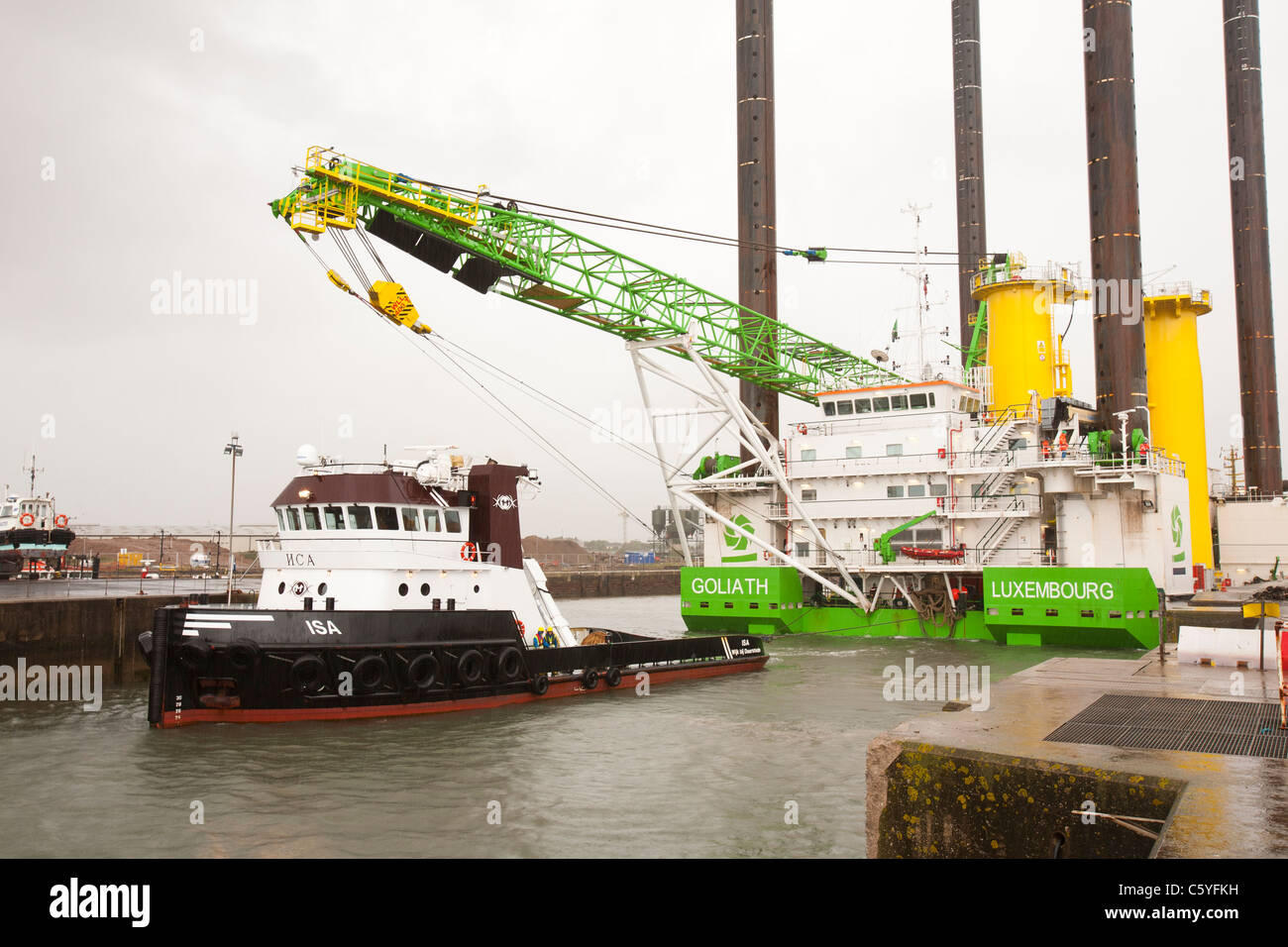 The jack up barge, Goliath being towed out by tug to the Walney ...