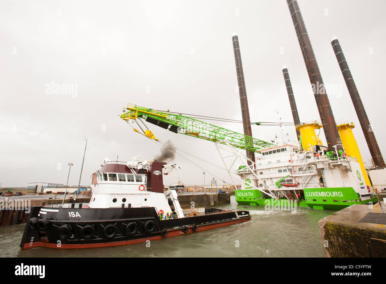 The jack up barge, Goliath being towed out by tug to the Walney ...
