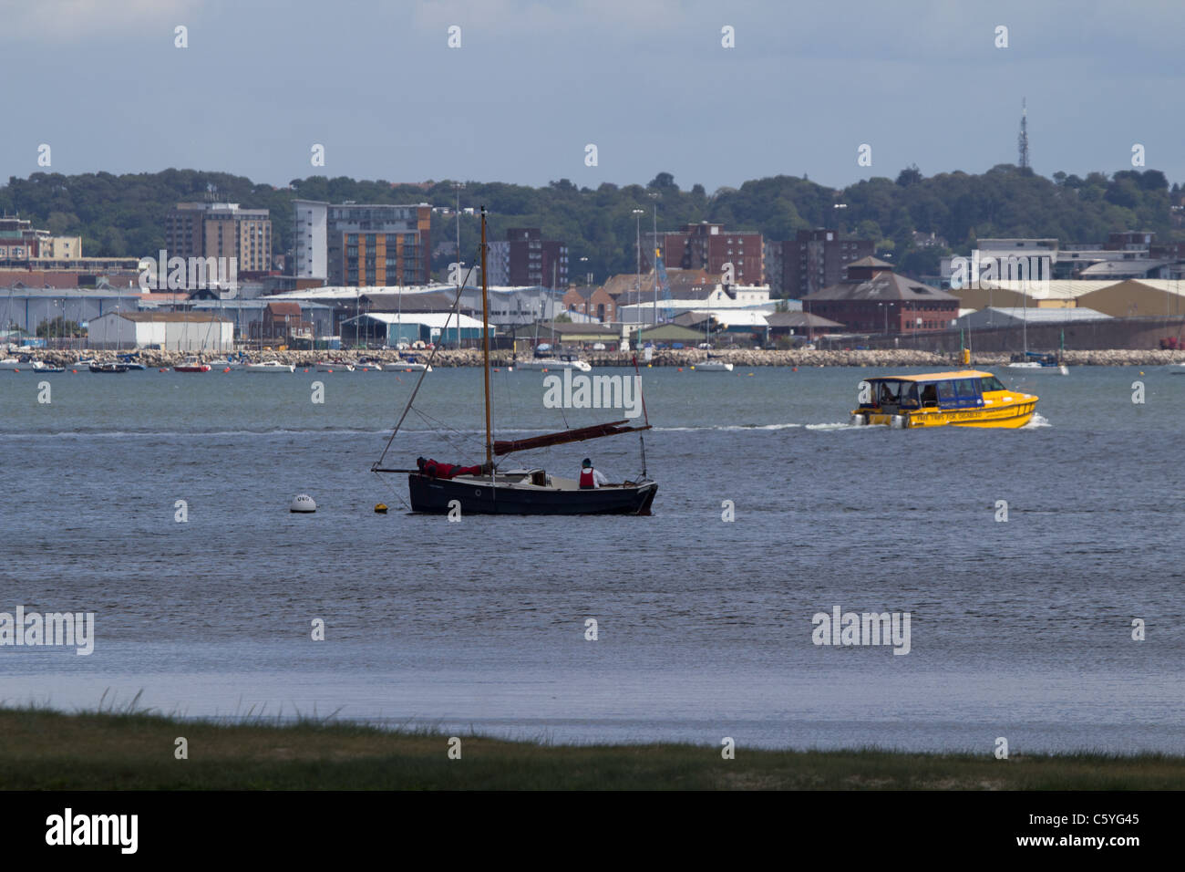 Traditional sailing boat and ferry in Poole Harbour from the Arne ...