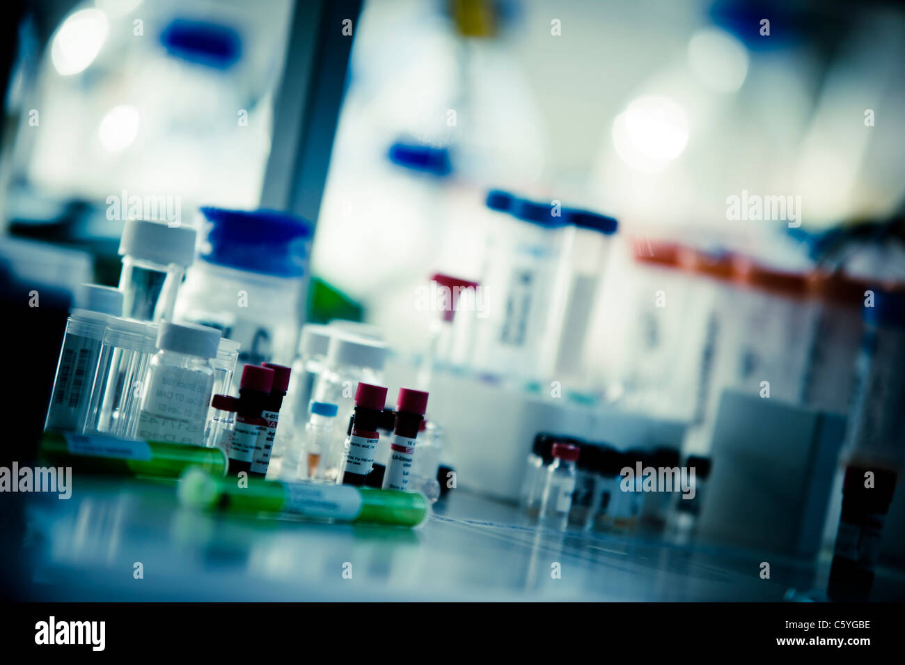 glass test tubes with colored tops on bench side in science laboratory ...