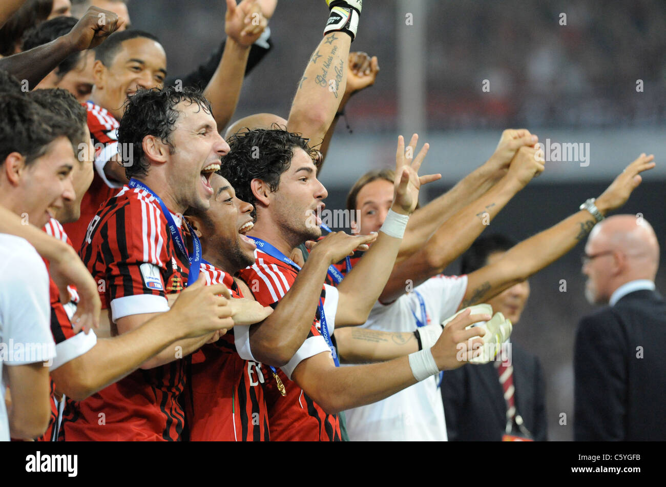 AC Milan players celebrate their win in the Italian Super Cup 2011 ...